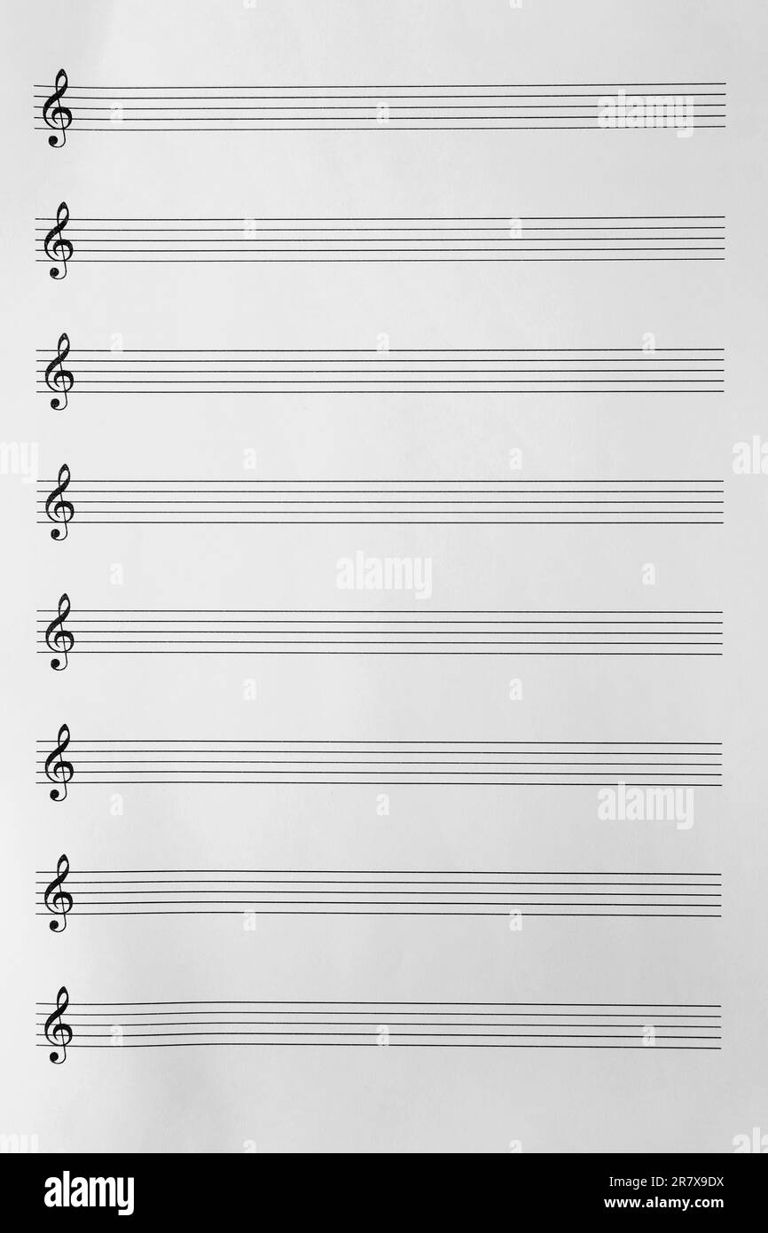Sheet with empty staves for music notes and treble clef as background ...