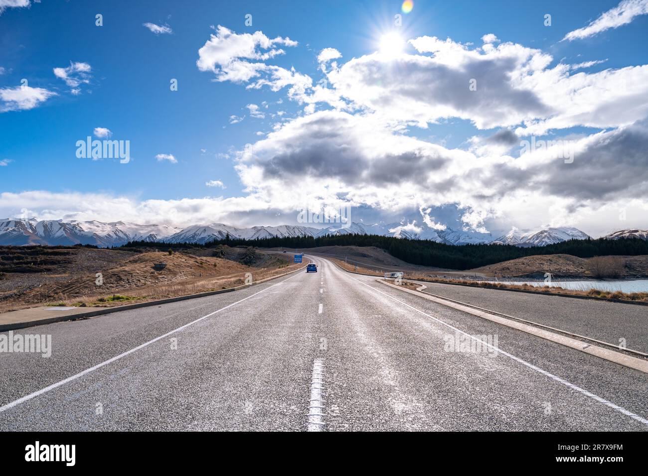 A scenic landscape of road to Aoraki Mount Cook - Lake Pukaki with blue ...