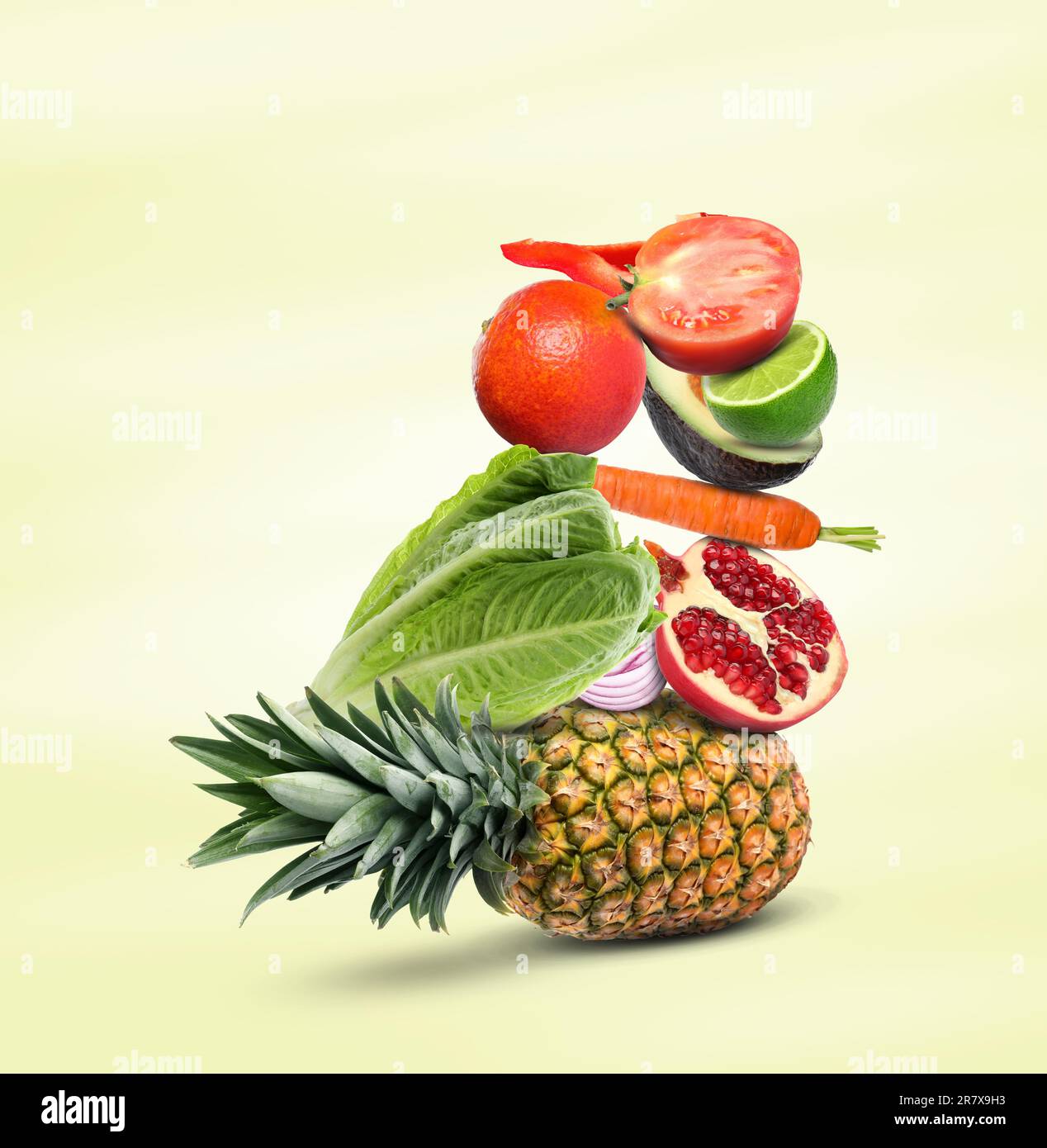 Stack of different vegetables and fruits on pale light yellow ...