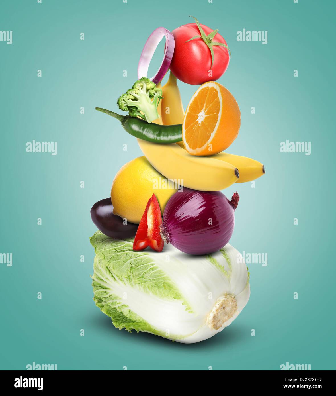 Stack of different vegetables and fruits on light sea green background ...