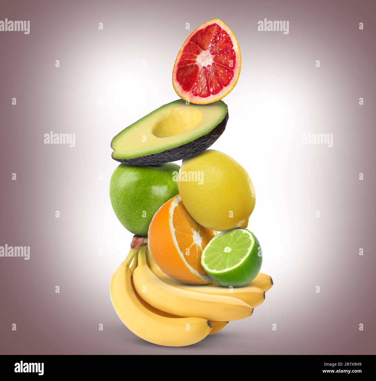 Stack of different fresh fruits on pale brown gradient background Stock ...
