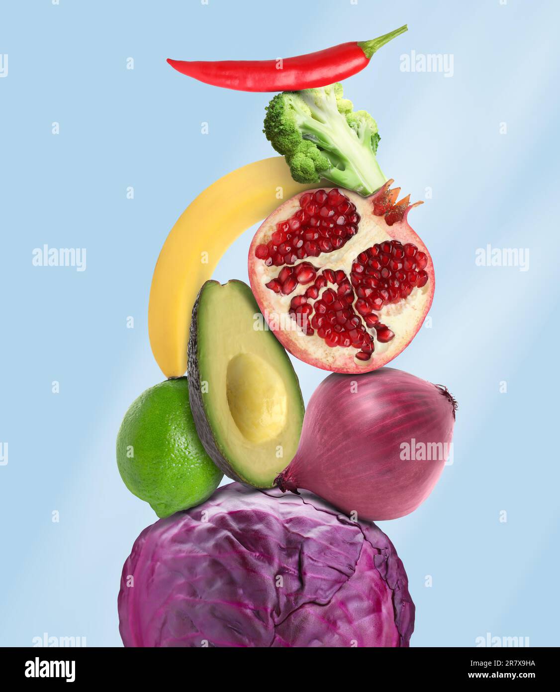 Stack of different vegetables and fruits on pale light blue background ...