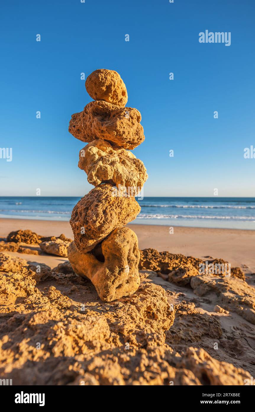 Group of five limestone rocks balancing atop each other on an empty ...