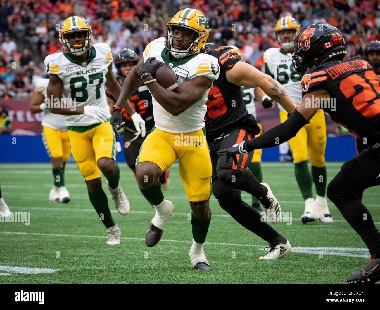 Edmonton Elks running back Kevin Brown (4) is chased by B.C. Lions ...