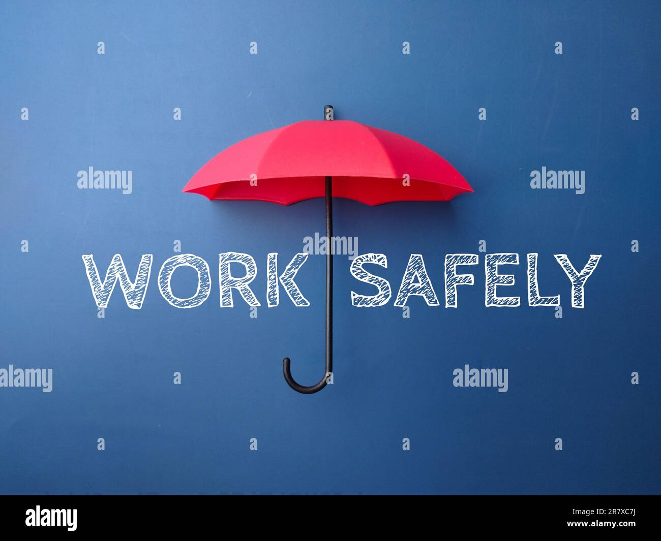 Red umbrella with the word WORK SAFELY on a blue background Stock Photo ...