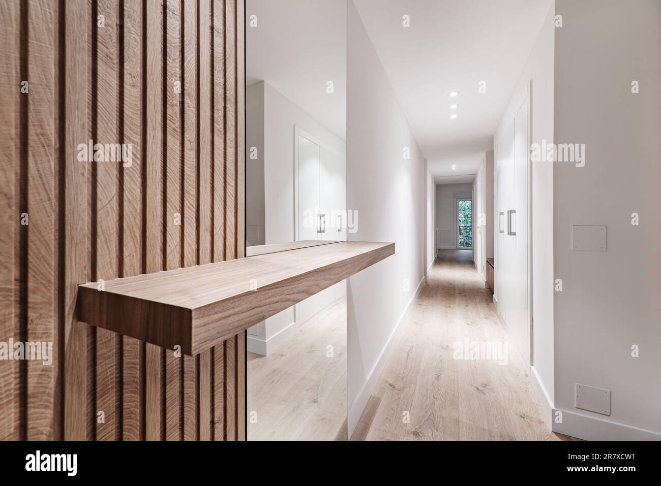 Entrance hall and corridor of a house with cabinets and wooden shelves ...