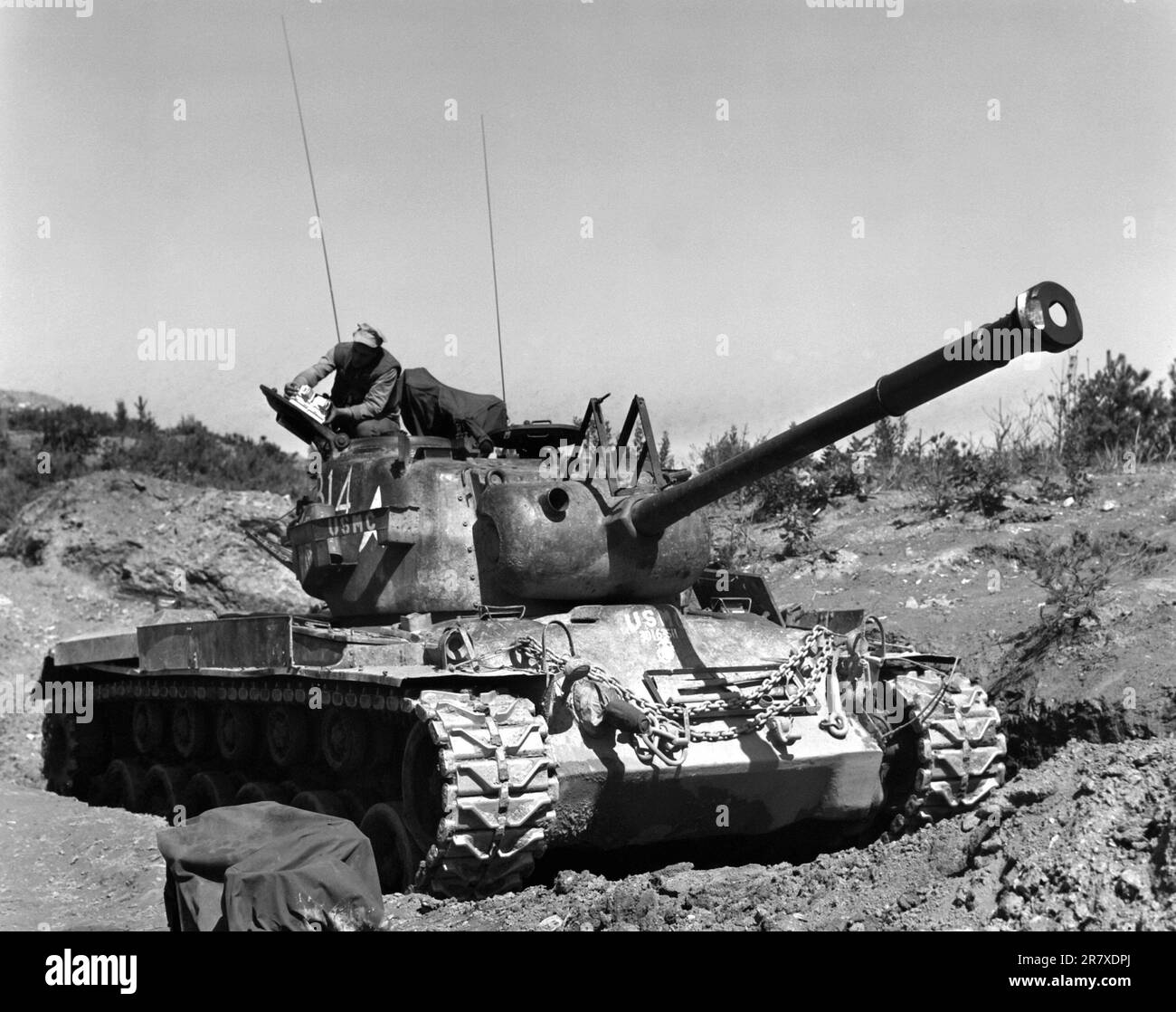 A 1st Marine Division tank crew member is careful not to let the hatch ...