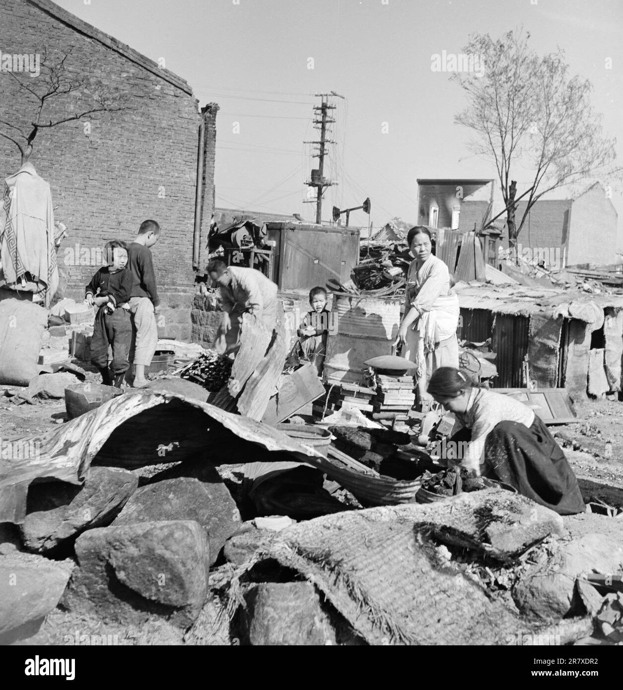 Civilians recovering building materials from the ruins in Seoul during ...