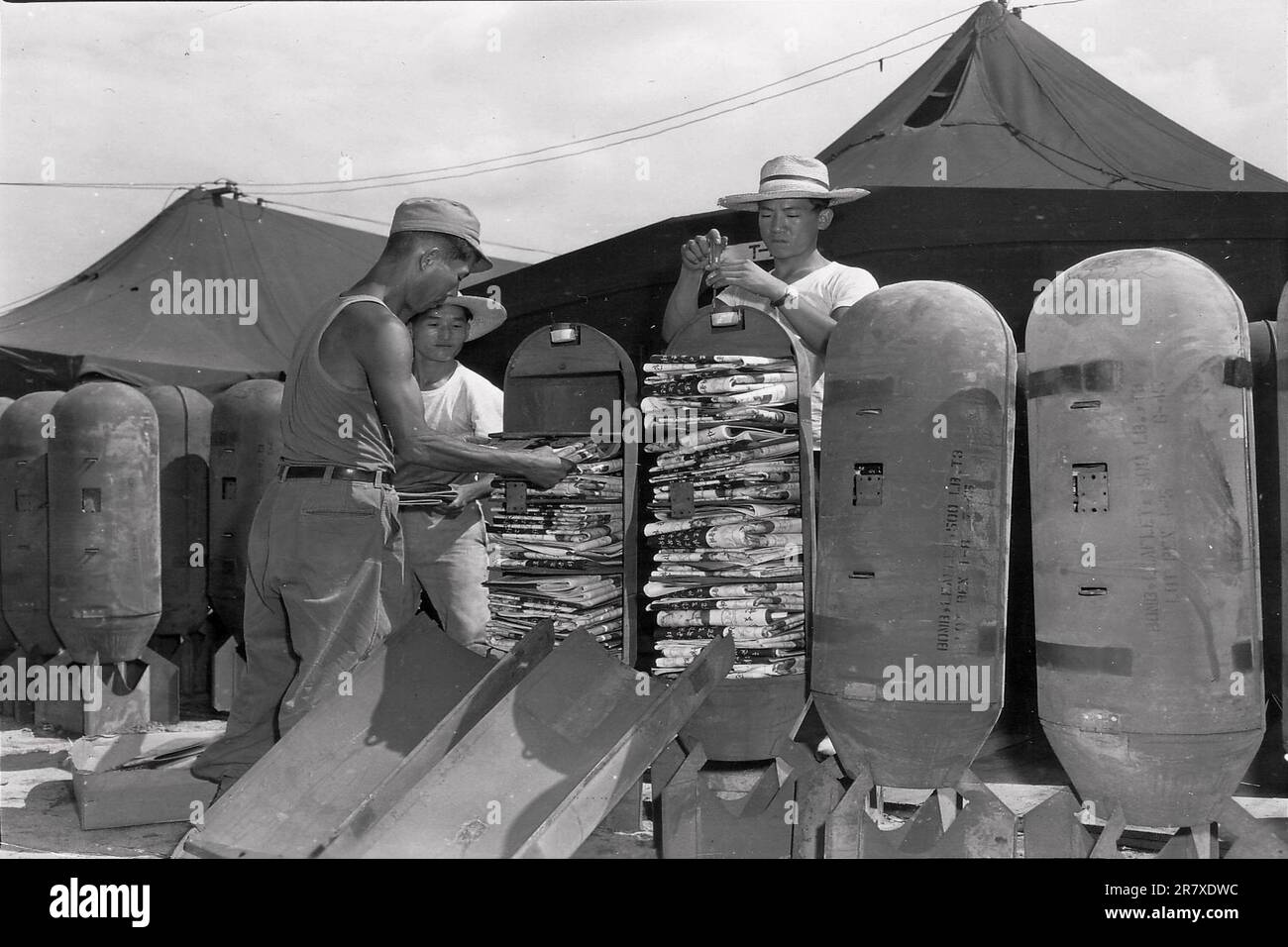 A Korean War leaflet drop being organised. The leaflets are packed into ...