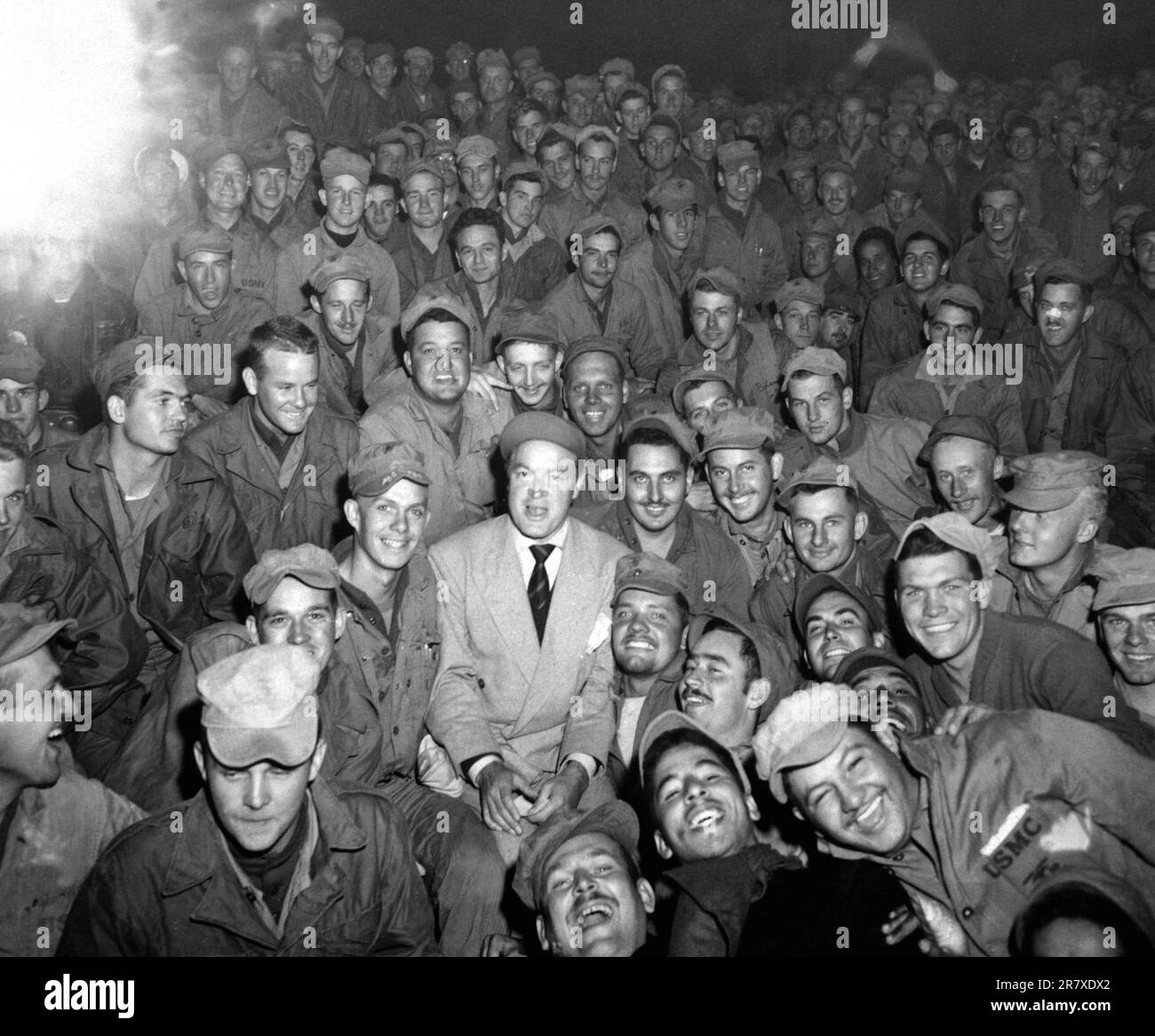 Bob Hope, radio and screen star, sits with men of X Corps, as members ...