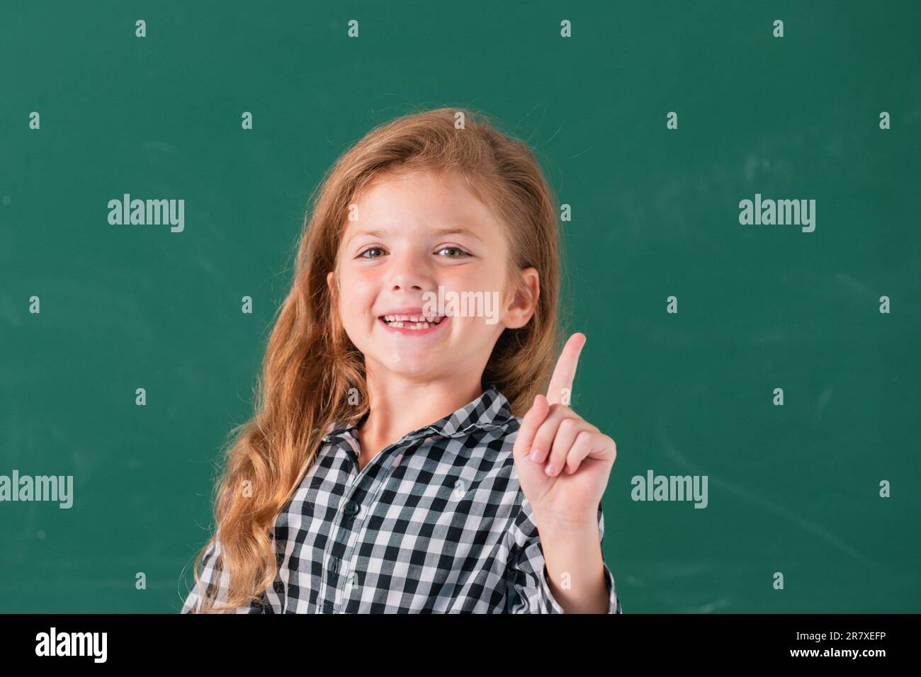 Portrait of school girl nerd pupil with surprising expression pointing ...