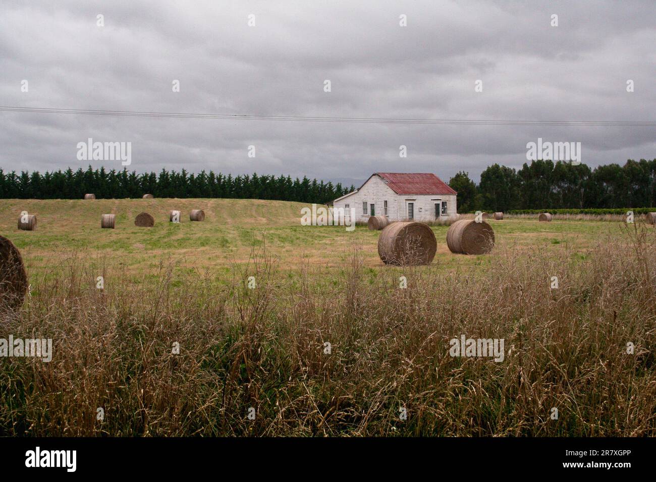 White wooden building with a red roof in a rural farming and vineyard ...