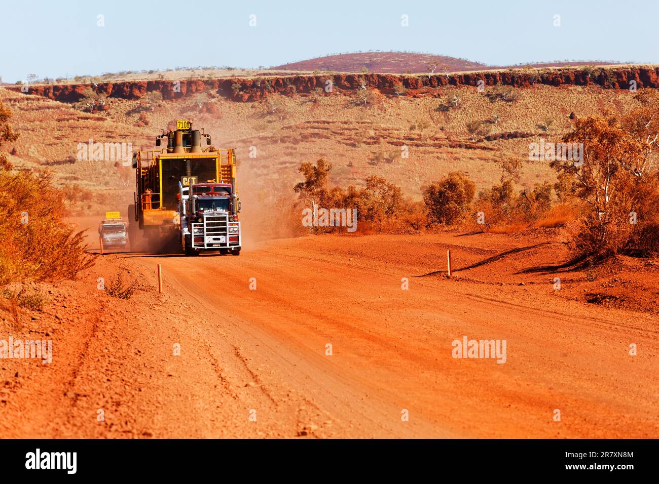 994K large wheel loader being transported on red dirt road in ...