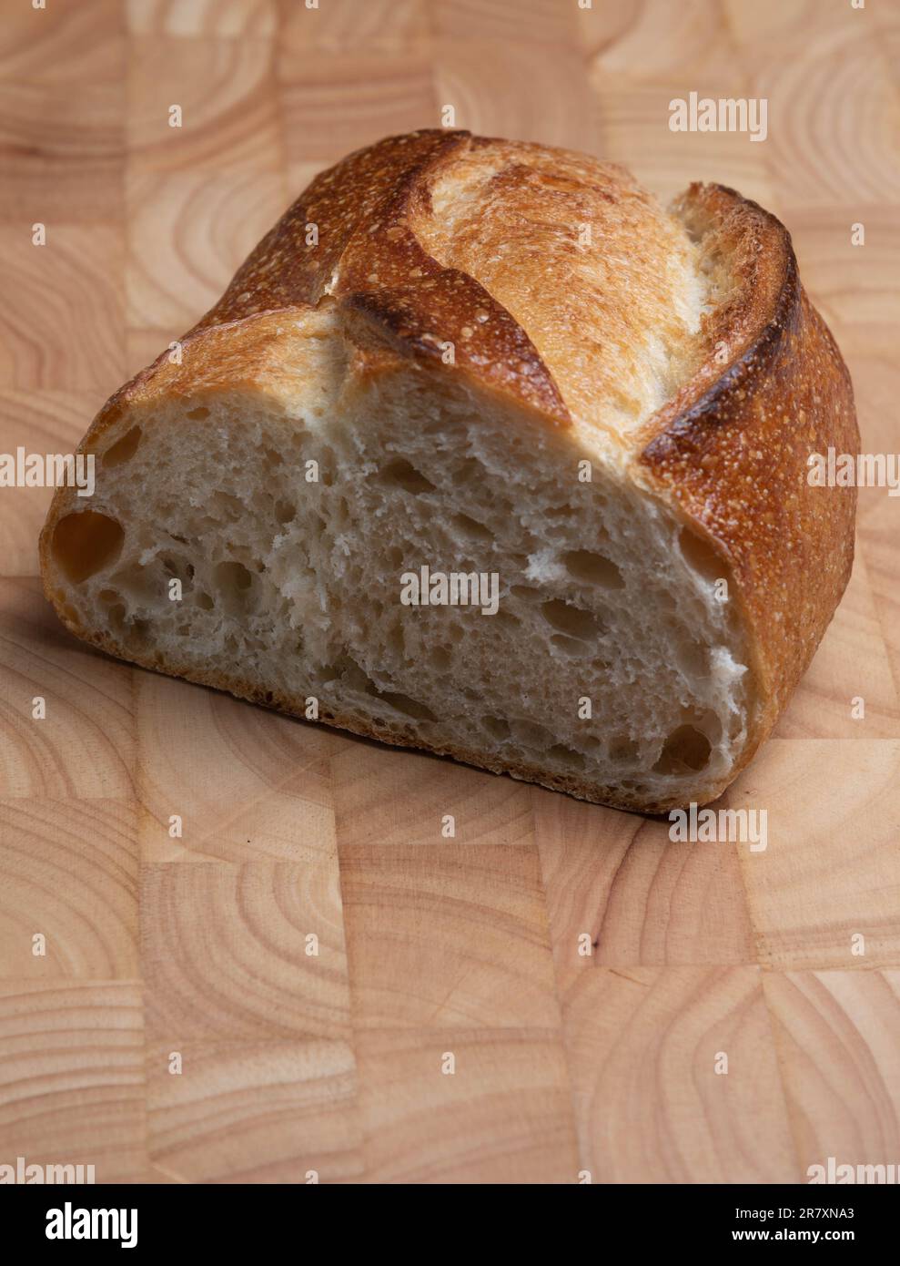 Homemade sourdough crusty loaves of bread on wooden background. Still ...