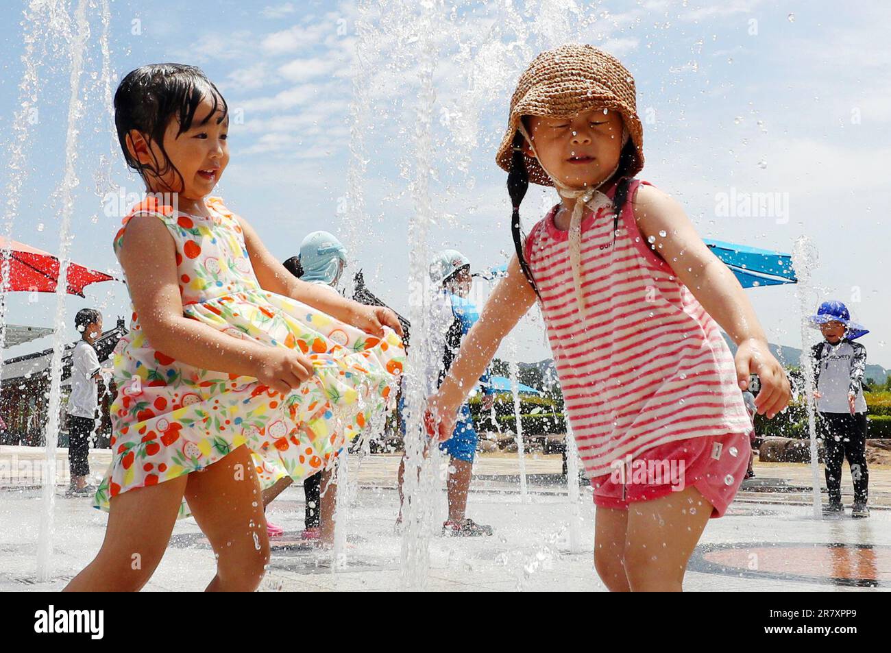 18th June, 2023. Heat wave Children play in a fountain at a square in ...