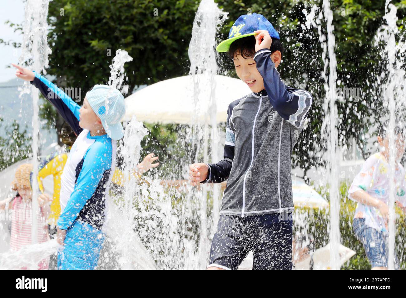 18th June, 2023. Heat wave Children play in a fountain at a square in ...