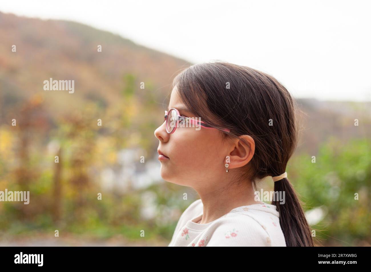 Portrait of a beautiful little girl with eyeglasses outdoors Stock ...