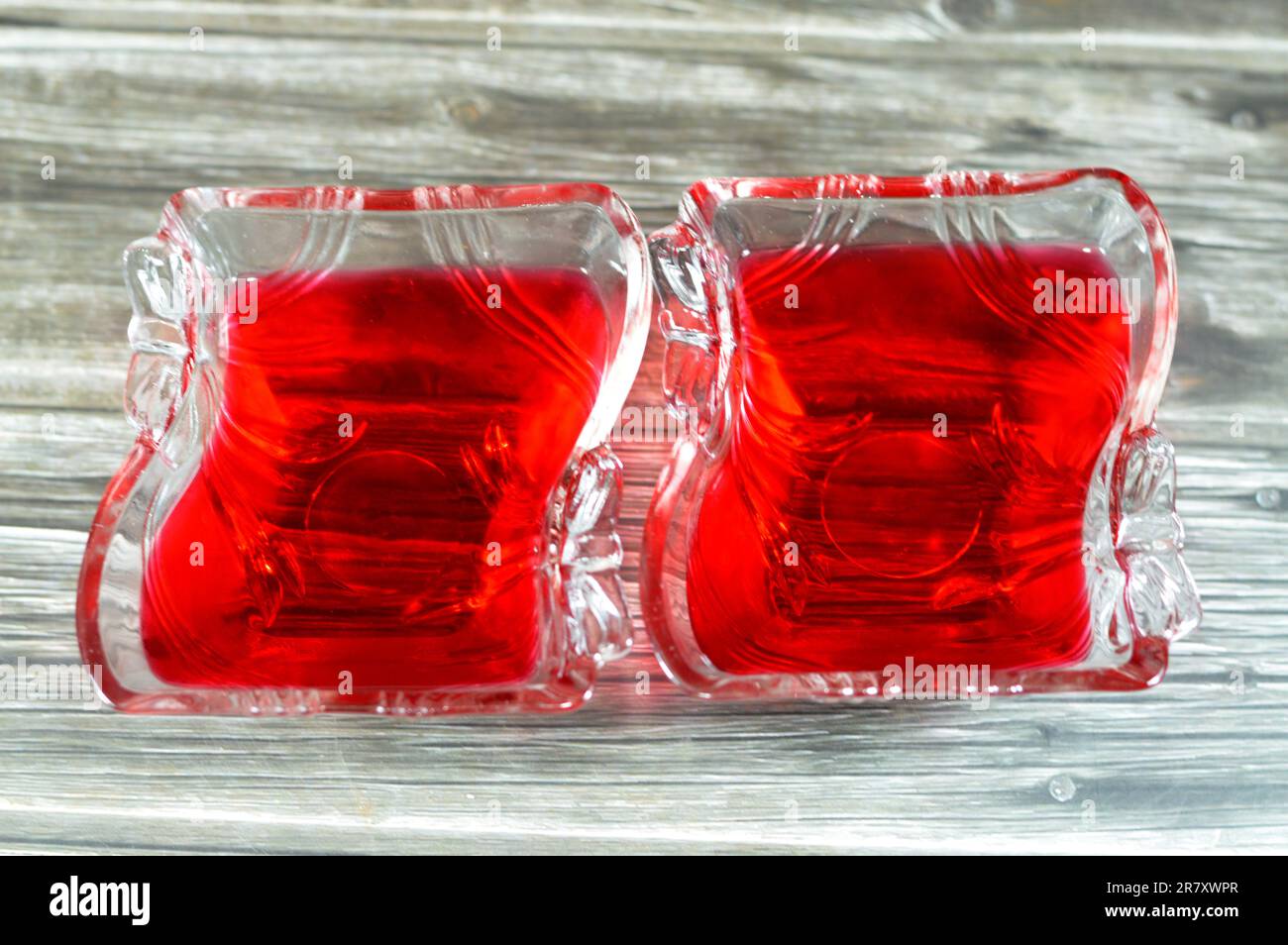 A close up of a delicious sweet red jelly pudding strawberry flavored ...