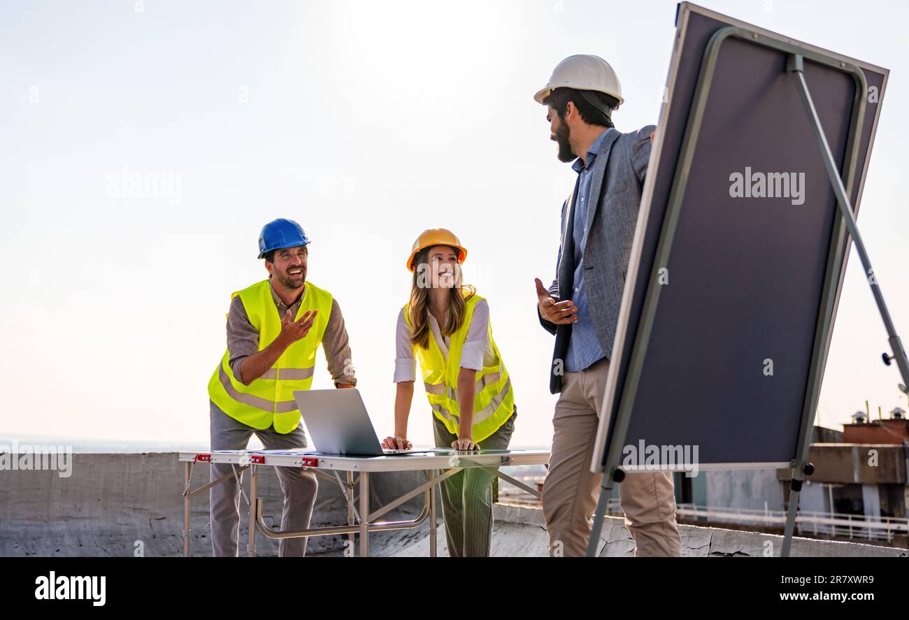 Group of engineers, architects, business partners at construction site ...