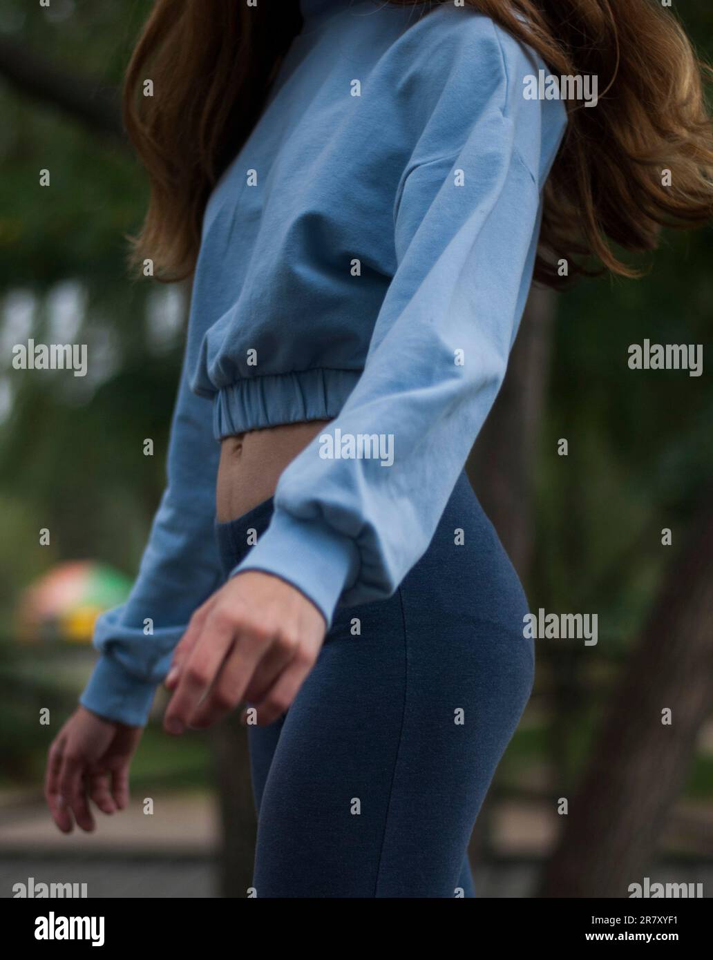 Athletic body of a girl in blue gym suit in cloudy rainy weather Stock ...