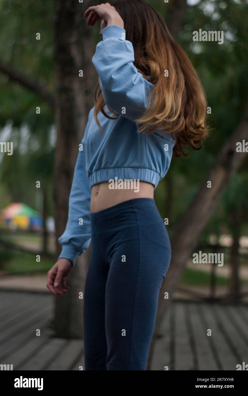 Athletic body of a girl in blue gym suit in rainy weather Stock Photo ...