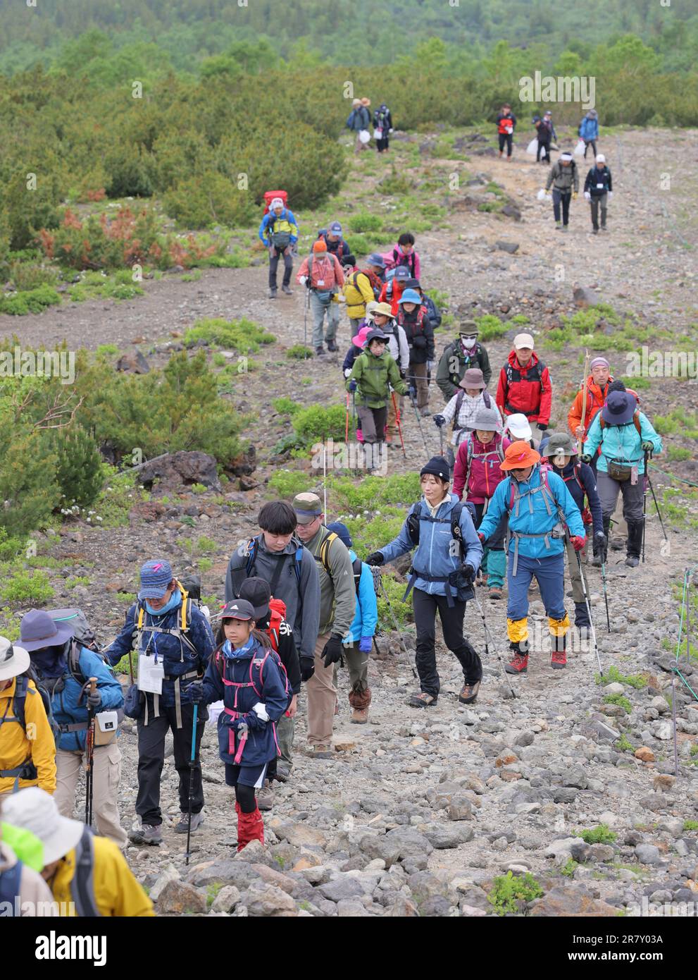 Climbers walk on Mt. Tokachi where the climbing season starts in Biei ...
