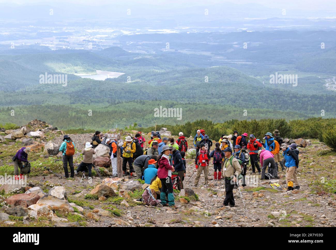 Climbers walk on Mt. Tokachi where the climbing season starts in Biei ...