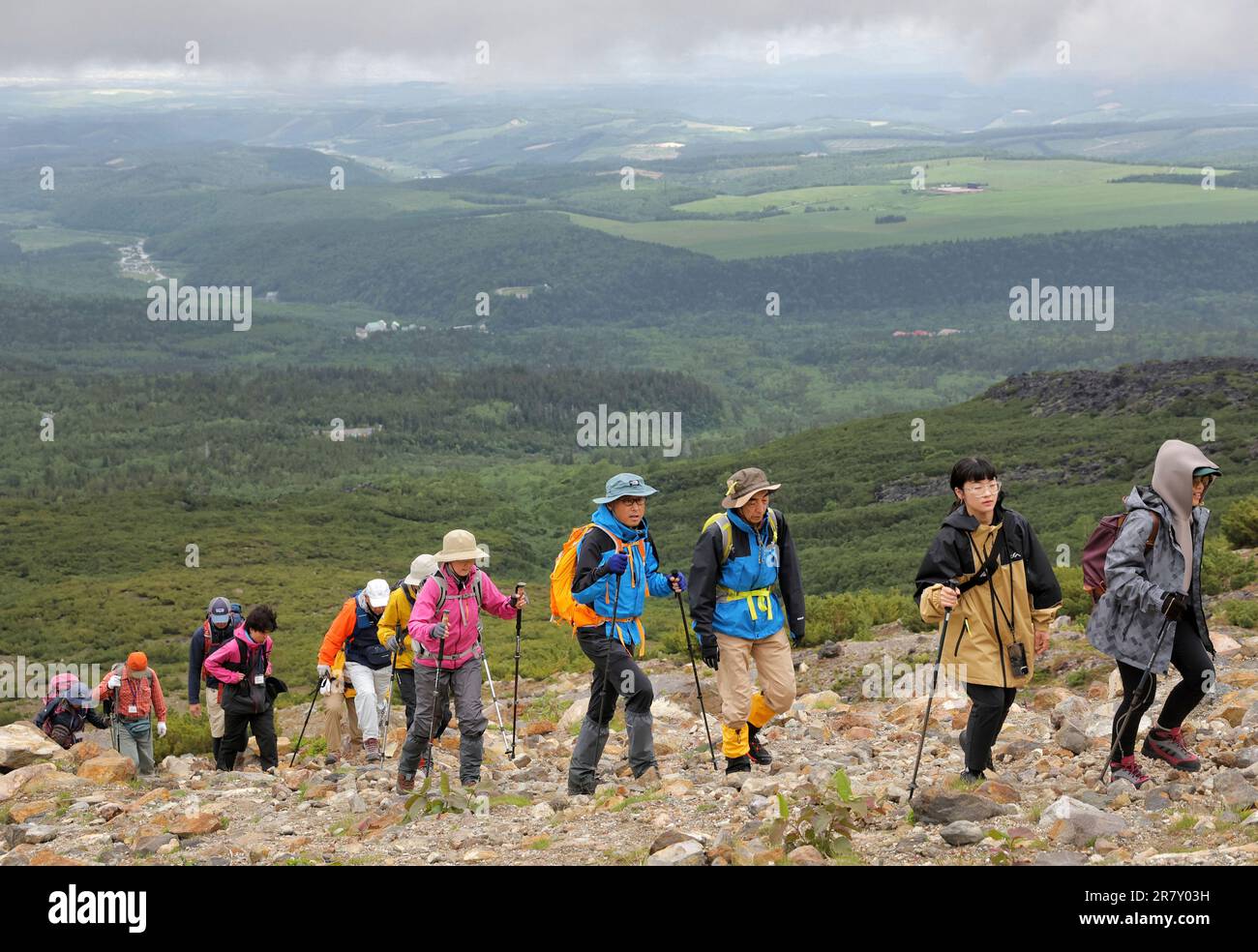 Climbers walk on Mt. Tokachi where the climbing season starts in Biei ...