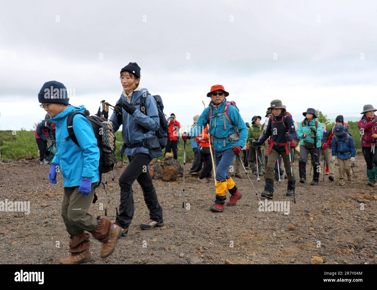 Climbers walk on Mt. Tokachi where the climbing season starts in Biei ...