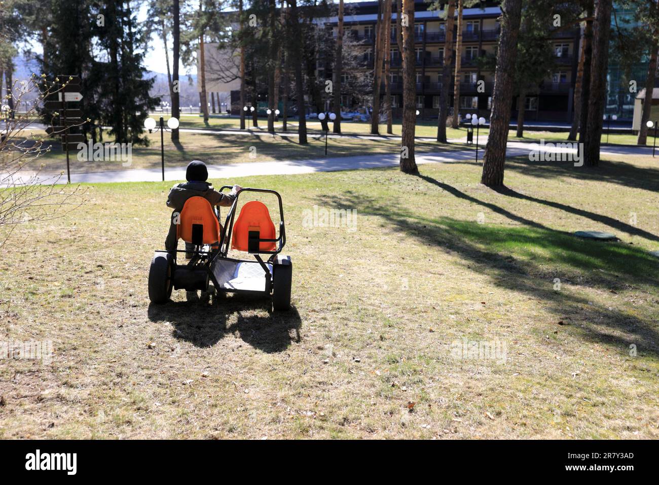 Child riding tricycle in park in spring Stock Photo - Alamy