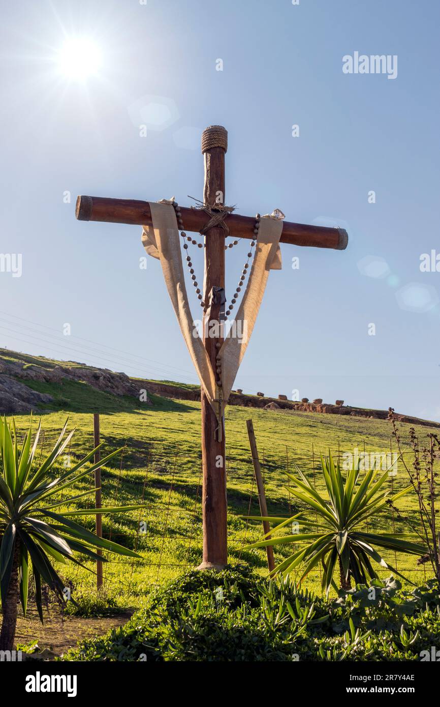 photo of wooden cross on the mountain, with a rosary, concept religion ...
