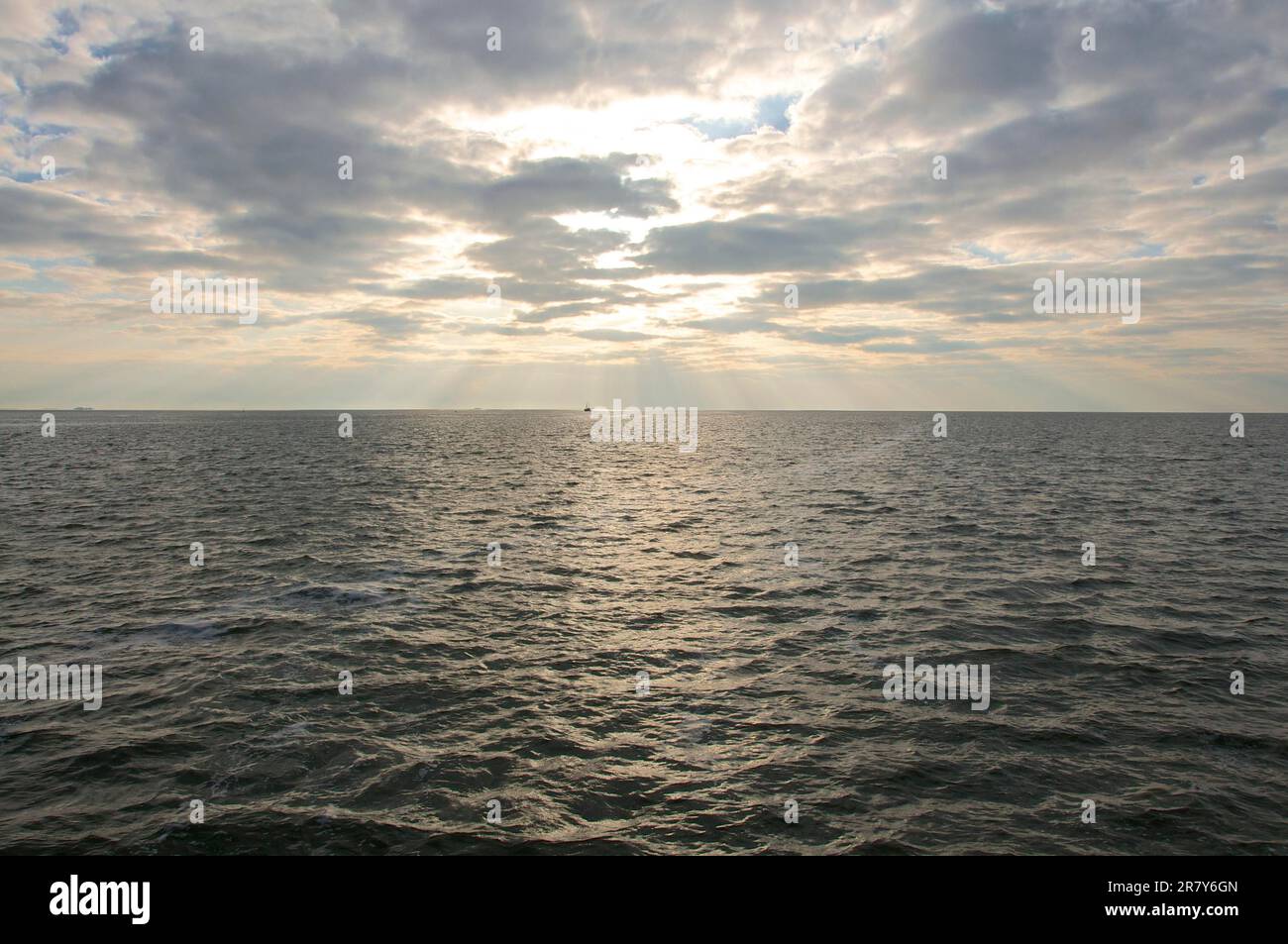 God rays in the Wadden Sea. A Trawler in the wadden Sea. Shrimp fishing ...