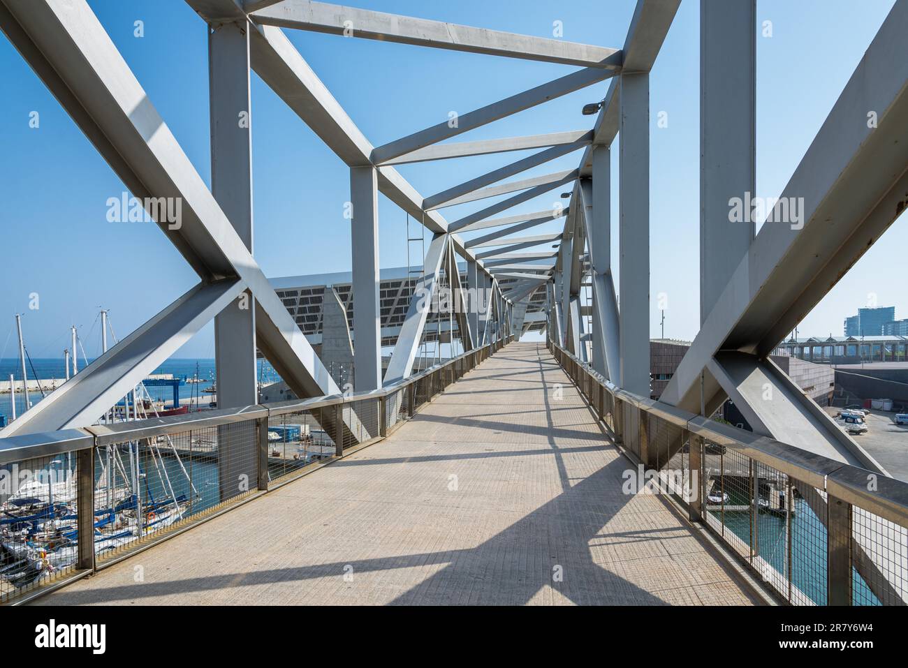 An industrial aesthetically pedestrian truss bridge leads above the ...
