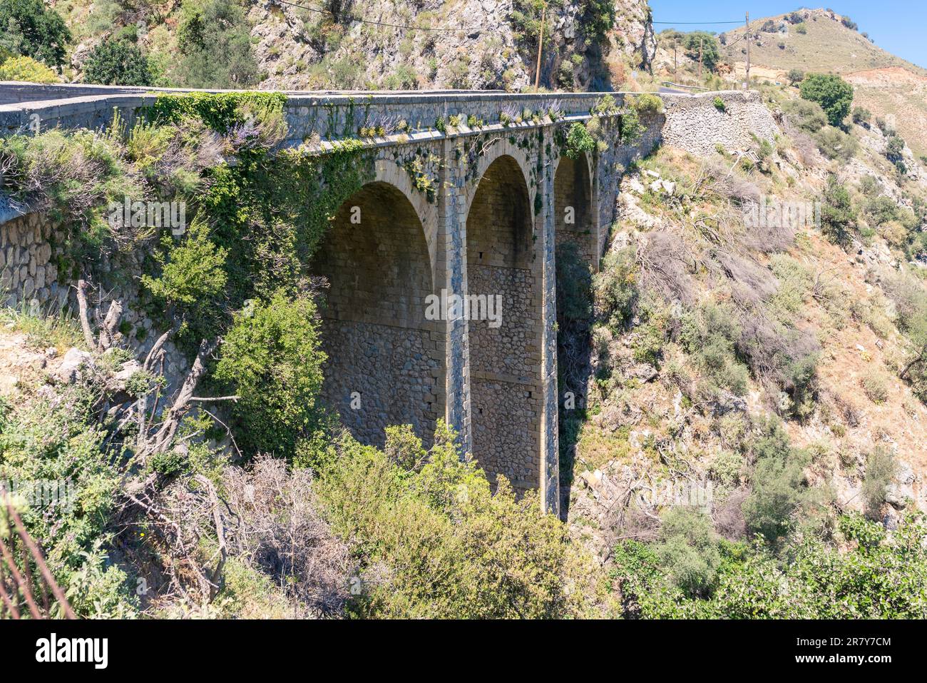 Old stone arch bridge on the old road to Rethymno. An arch bridge is a ...