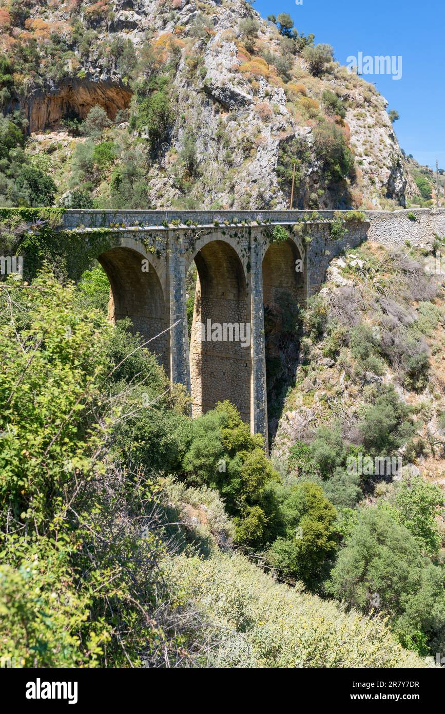 Old stone arch bridge on the old road to Rethymno. An arch bridge is a ...