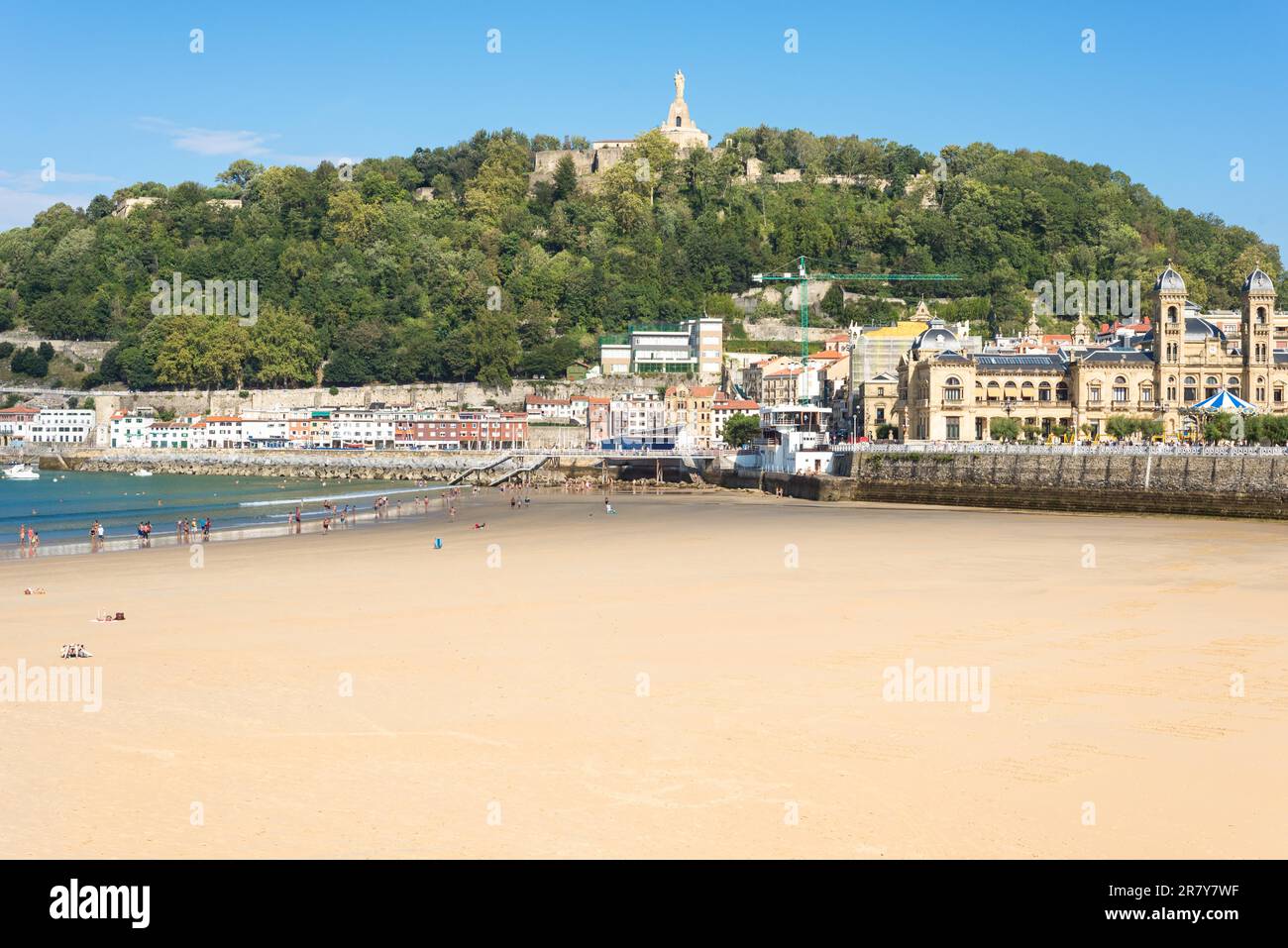 View to the mountain Urgull with the sculpture of Jesus. At the beach ...