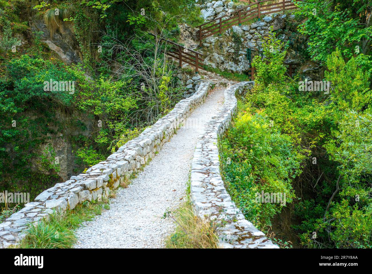 An old, arched stone bridge on the Canal del Texu trail between the ...