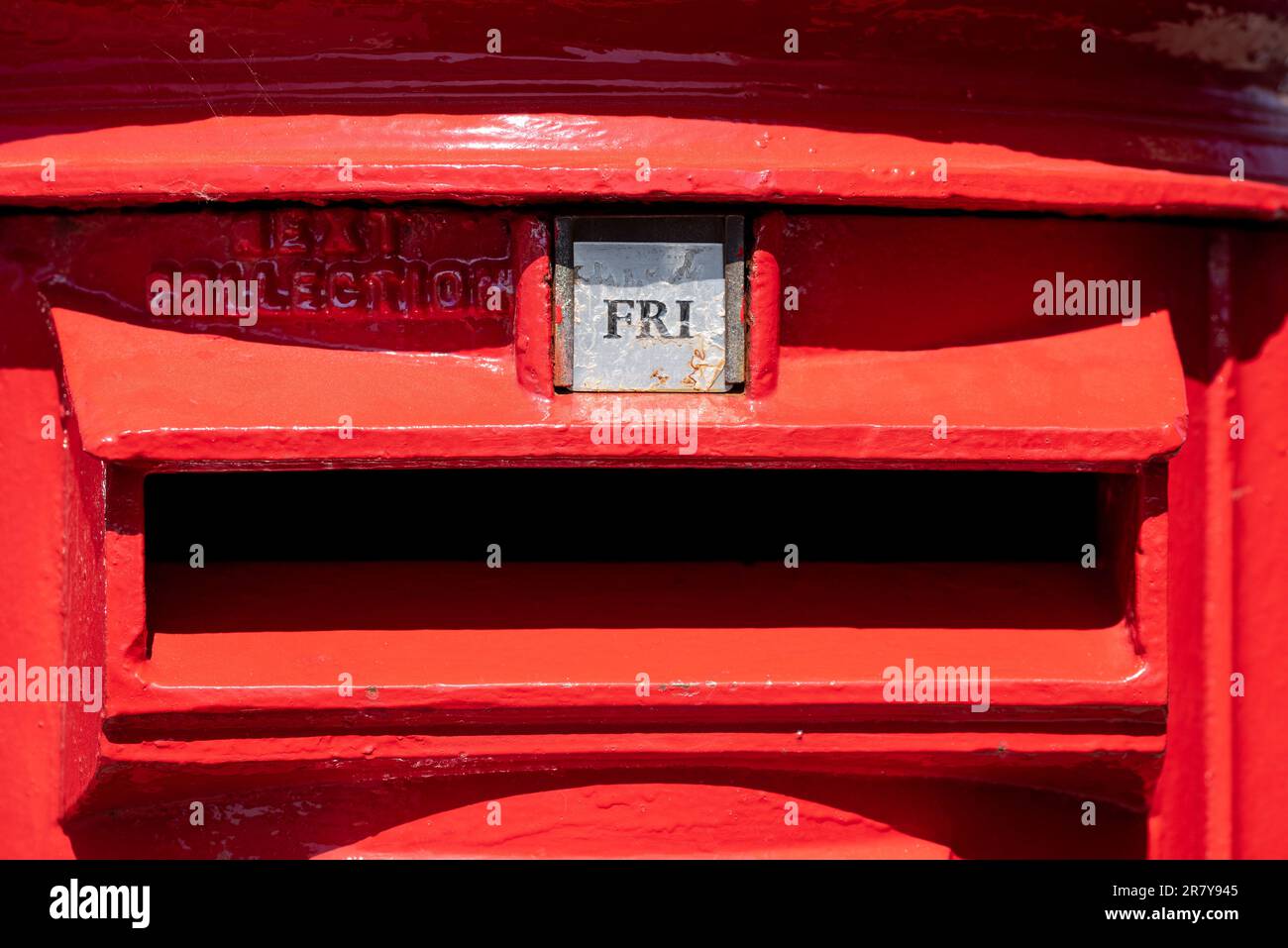 Close up image of the opening of a traditional red British post box ...