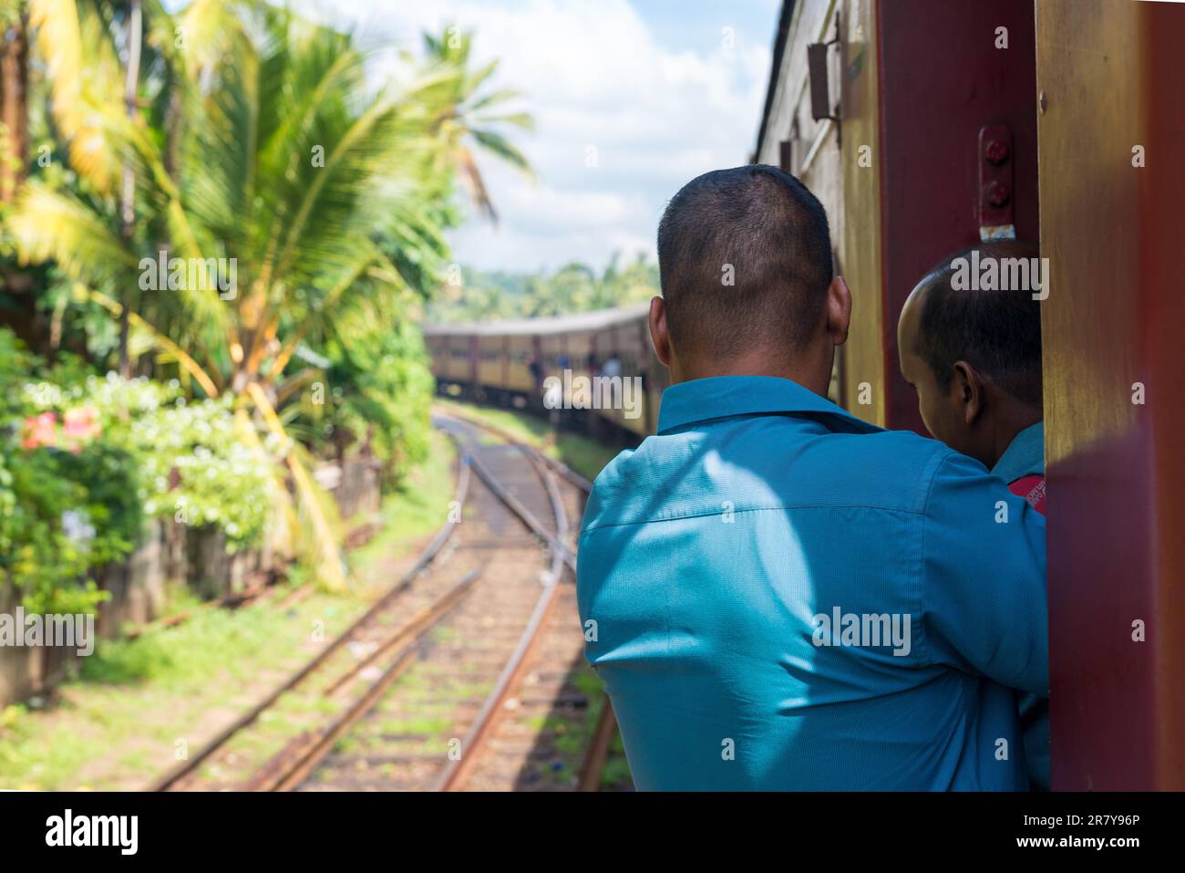 In the railroad car on the way to Colombo. Local people in and outside ...