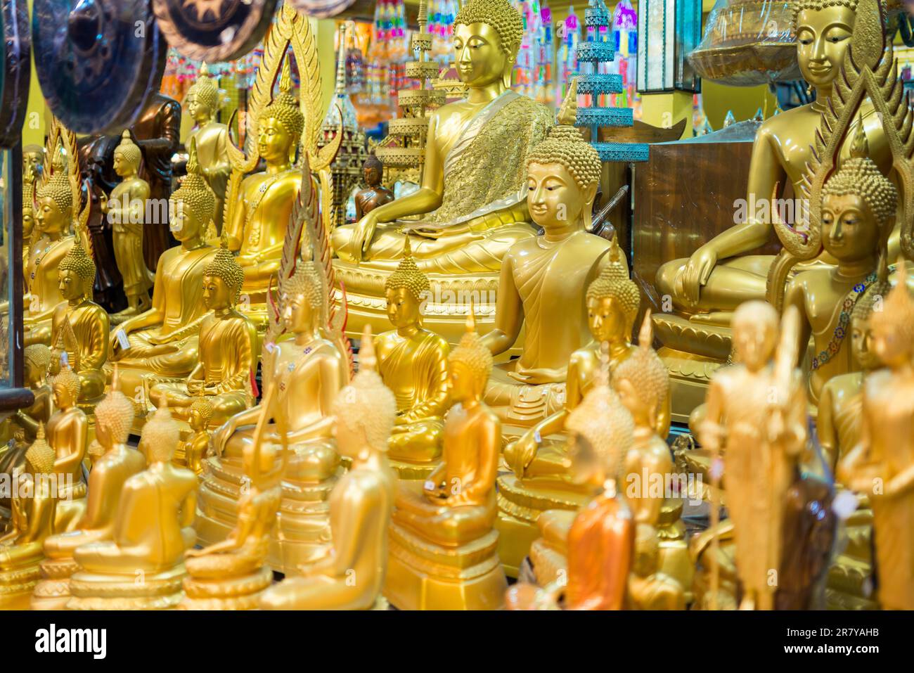 Chinese religious goods shop with different golden Buddhas in the city ...