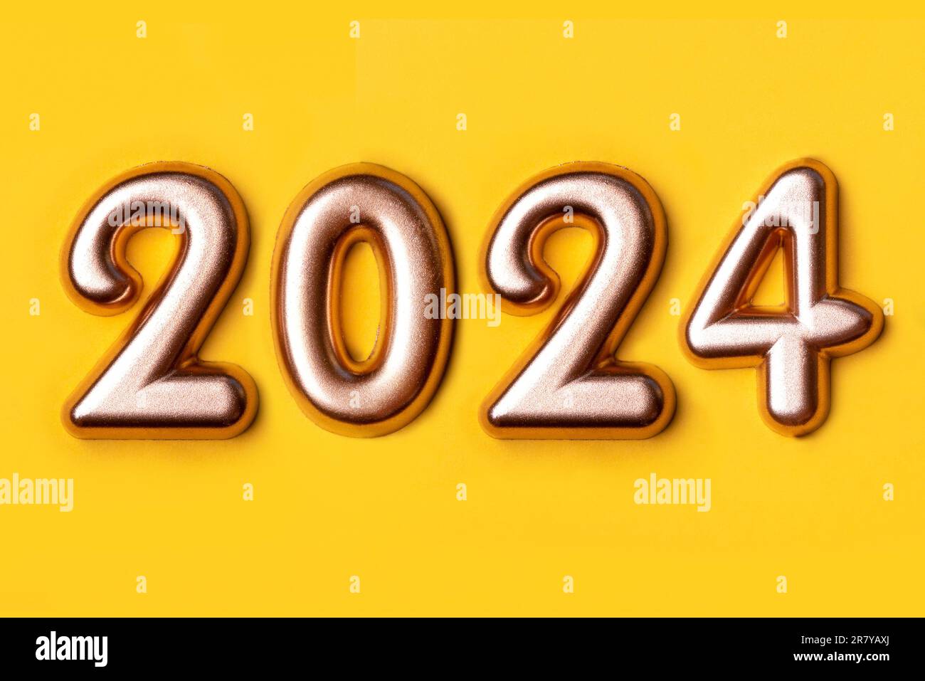 Metallic gold numbers 2024 on a yellow background Stock Photo - Alamy