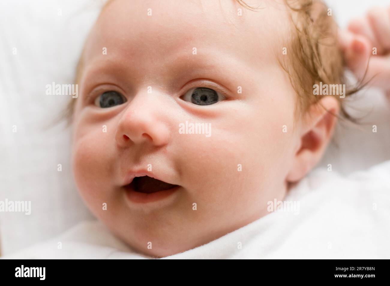Little baby looking around Stock Photo - Alamy