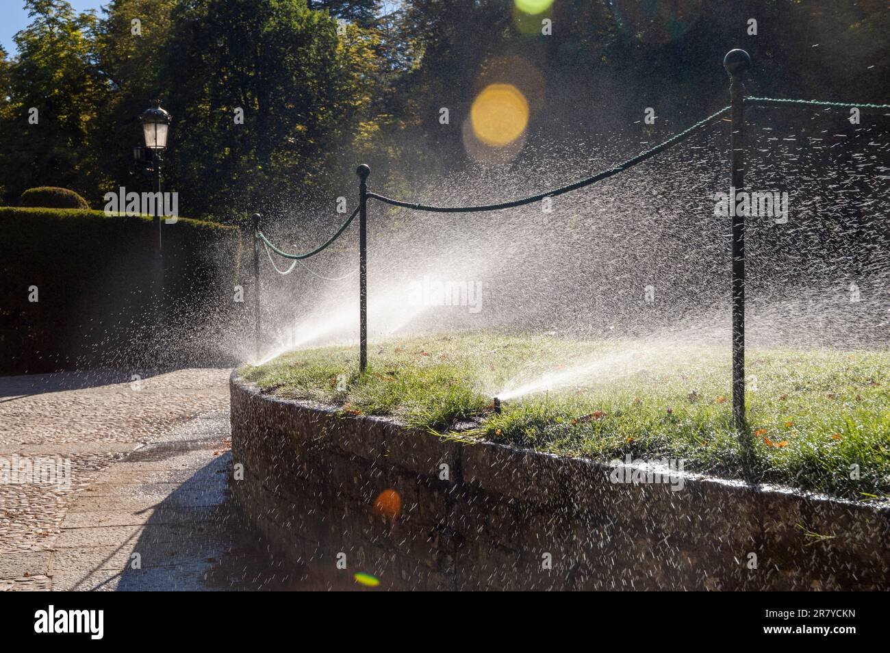 irrigation system with several sprinklers spraying a rain of water on ...