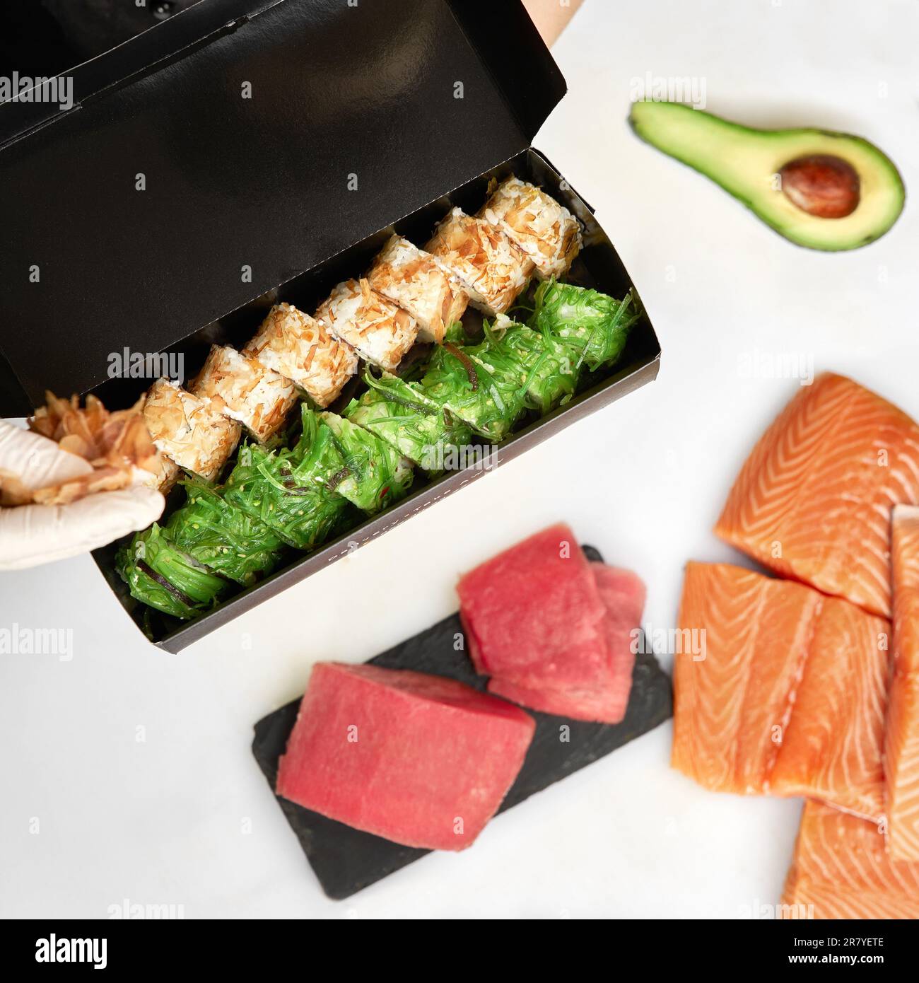 Sushi to go concept. Top view of takeaway box with sushi rolls and ...