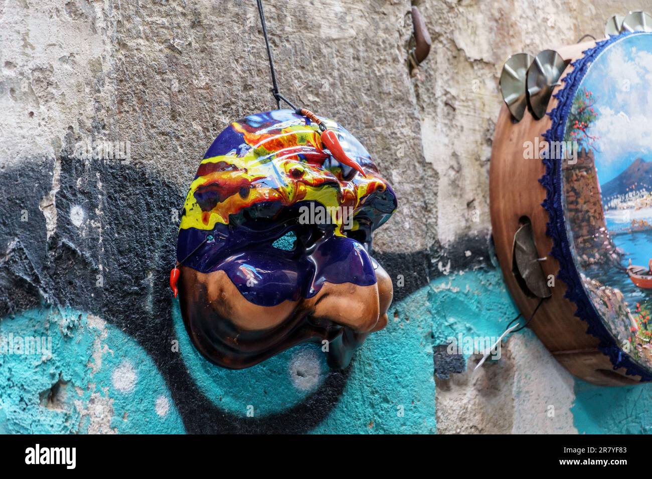 A Pulcinella Neapolitan comedy mask hanging on the wall on the streets ...
