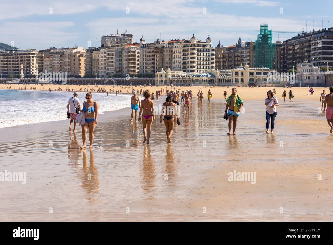 Walking on the Beach of La Concha, a sand beach with shallow waters. At ...