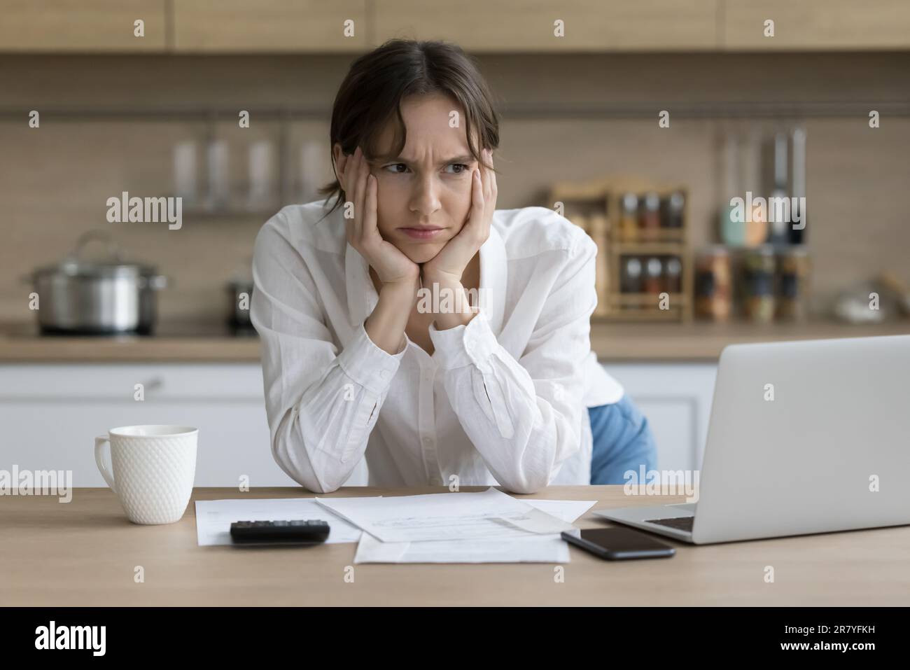 Upset woman thinking about solving financial problems Stock Photo - Alamy