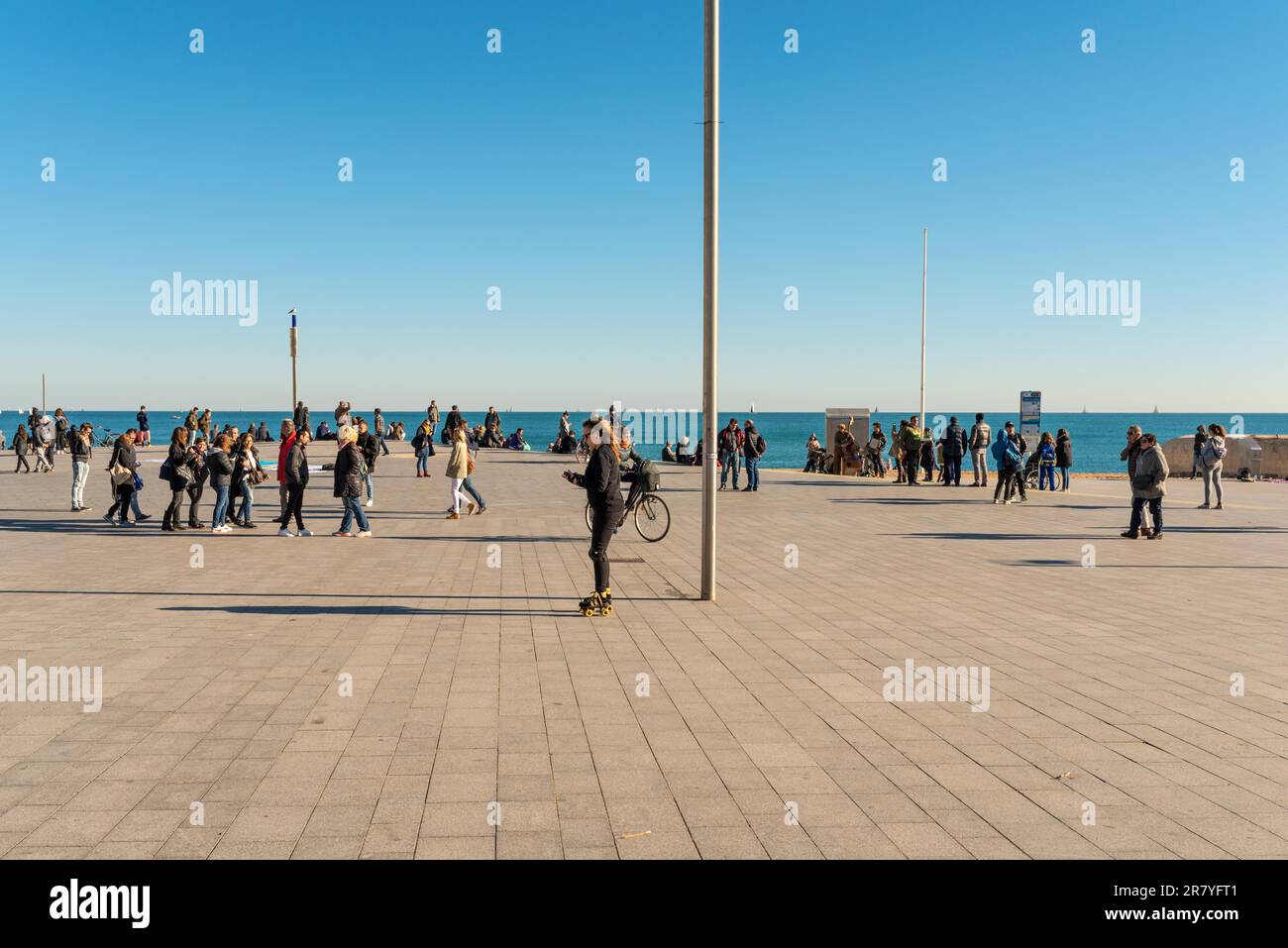 Sunny day at the beachside of Barceloneta. The promenade is very ...