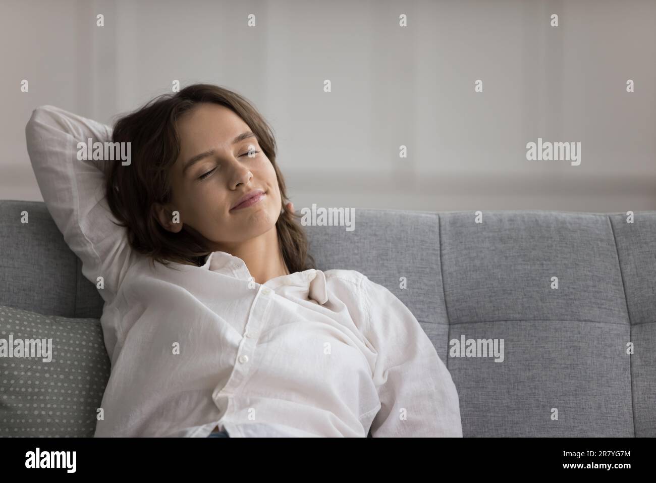 Beautiful young woman fell asleep on sofa Stock Photo - Alamy
