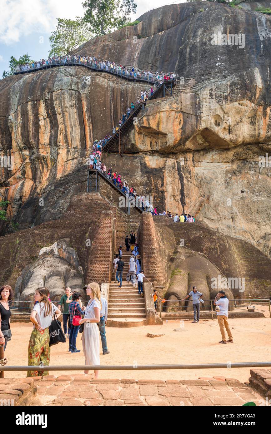 Big paws at the lions gate of the Sigiriya rock fortress. Pedestrians ...